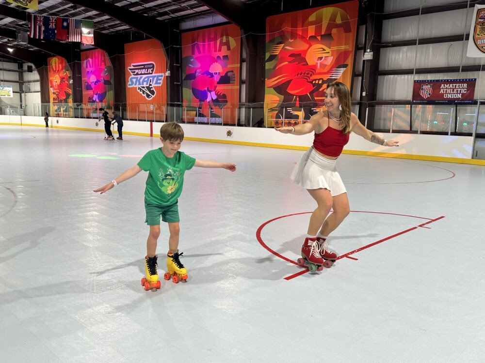 Instructor teaching boy to skate